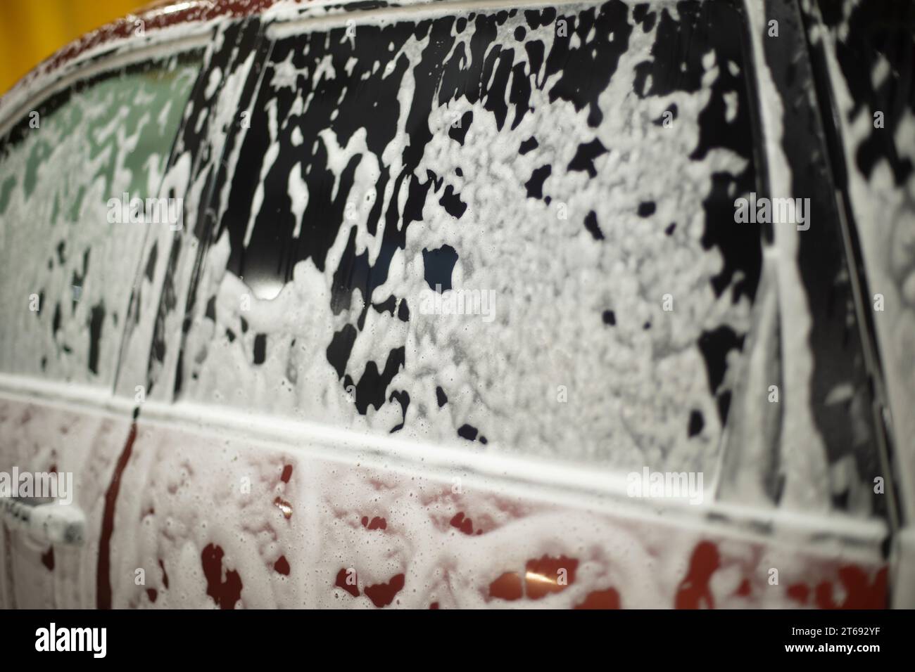 Car glass in foam. Car wash. Application of soap solution to transport ...