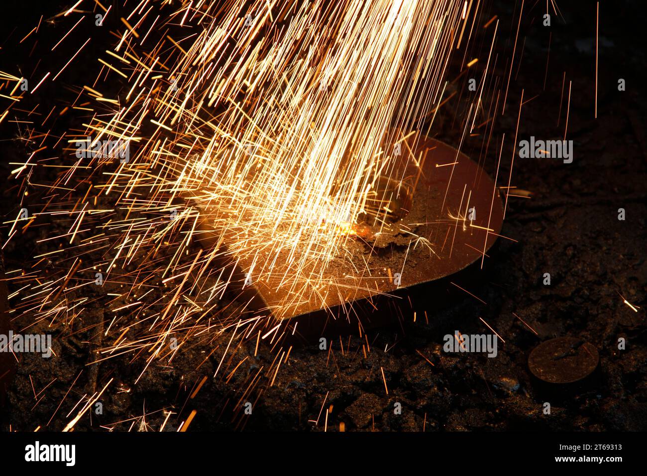 Sparks coming out of metal as a background Stock Photo - Alamy