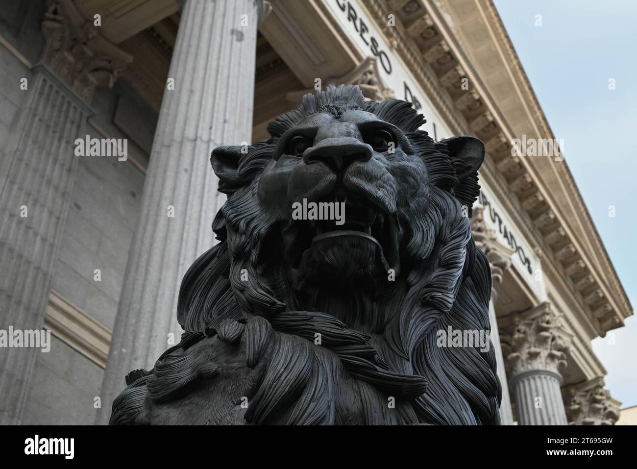 A large lion's head sculpture adorns the base of a modern architectural ...