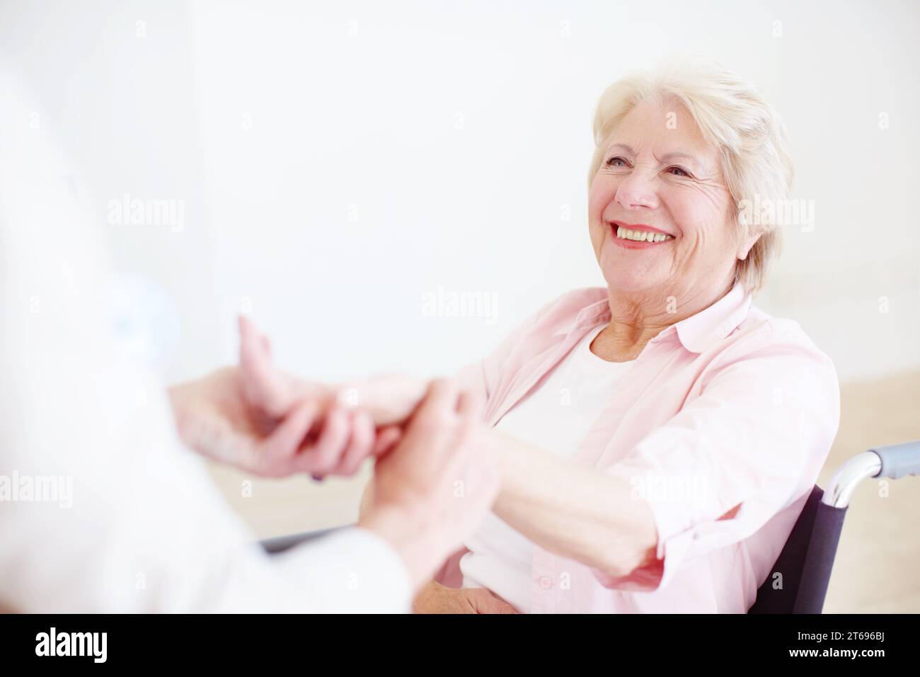 Shes getting stronger everyday. Senior woman in a wheelchair having her ...