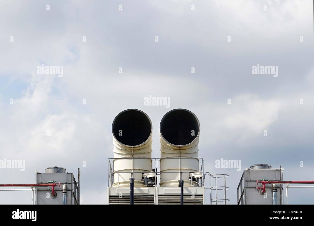 Industrial big chimneys with a air conditioner hot coil against the ...