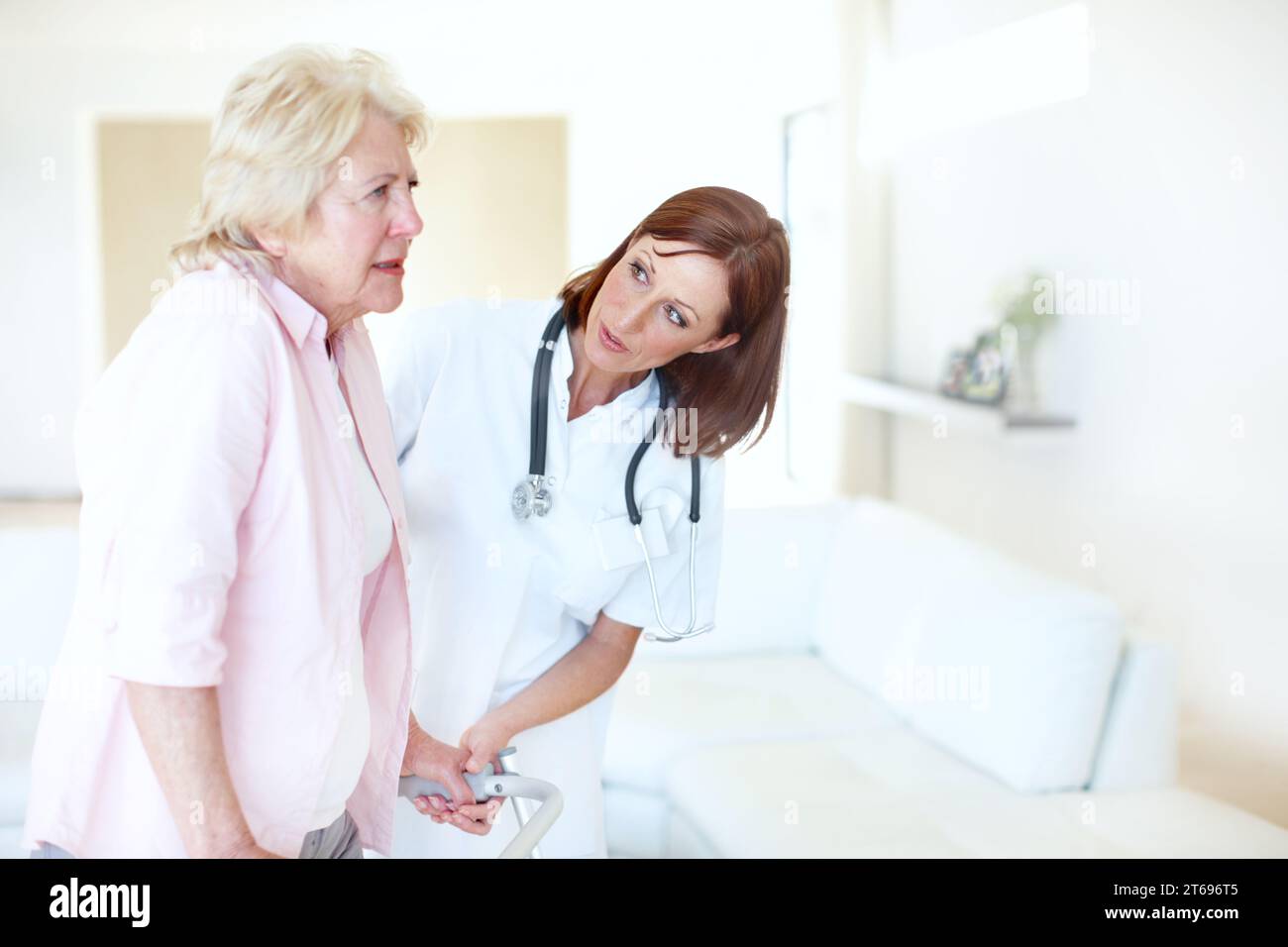Motivation and rehabilitation - Senior Care. Mature nurse assists her ...
