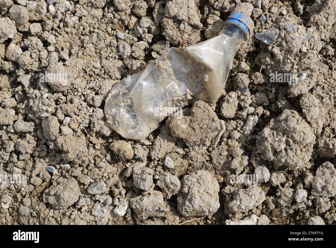 A plastic glass waste on pile of soil for planting trees, pollution of ...