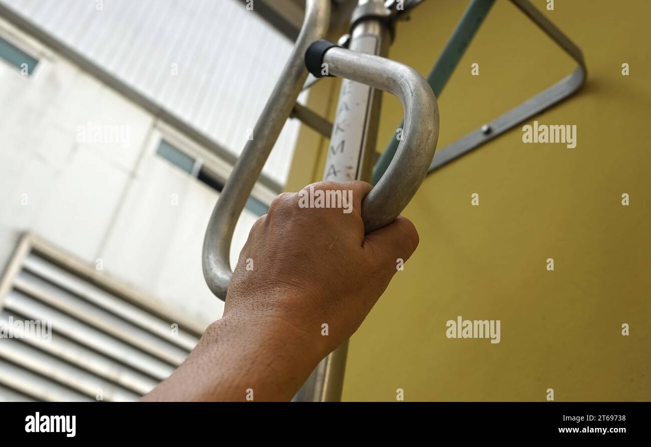 Closeup of a hand holding to pull an emergency shower of the after ...
