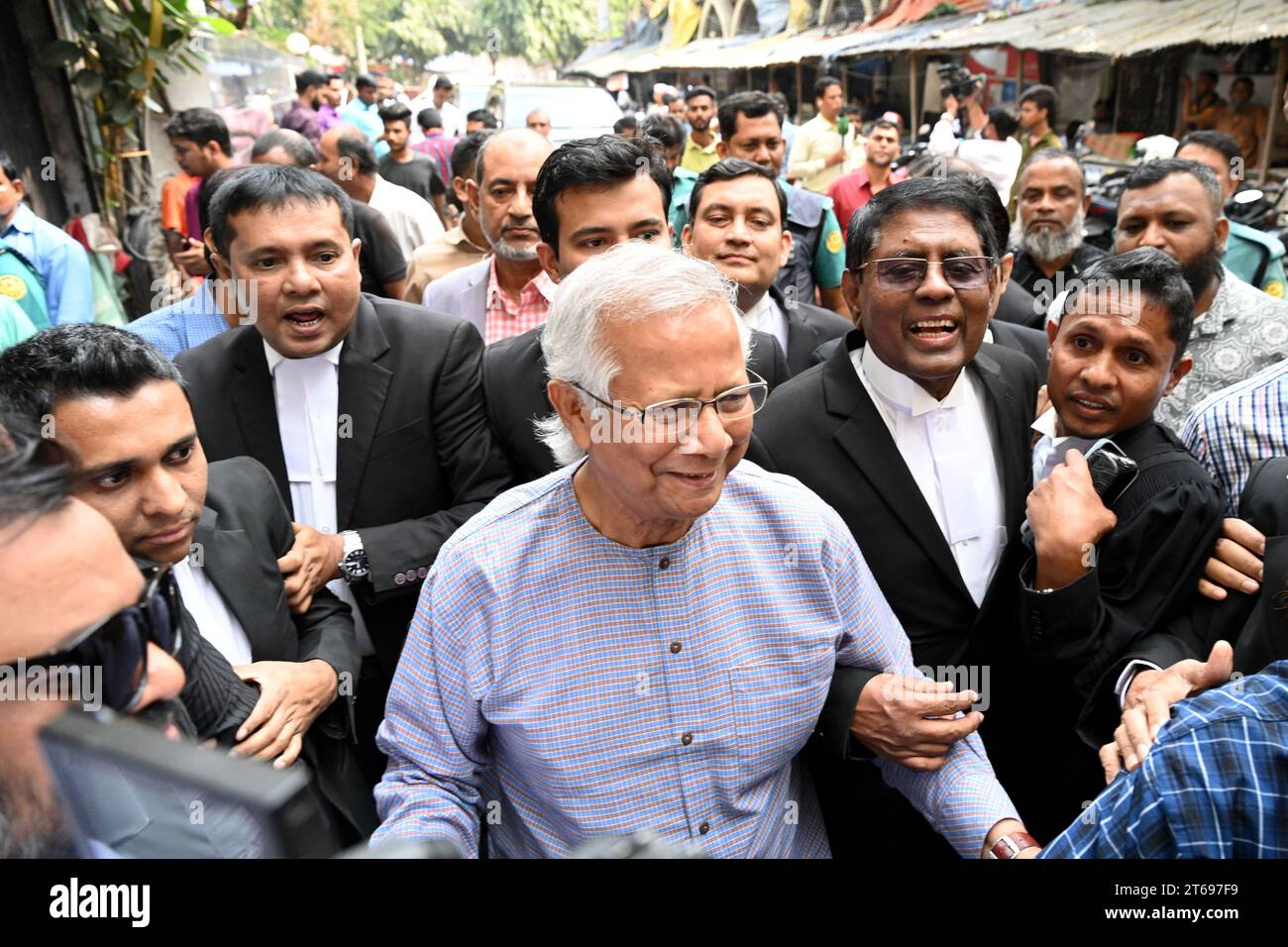 Nobel laureate Muhammad Yunus (C) arrives with his lawyers for a ...