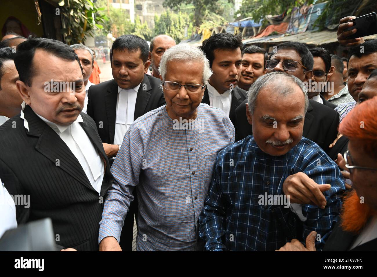 Nobel laureate Muhammad Yunus (C) arrives with his lawyers for a ...