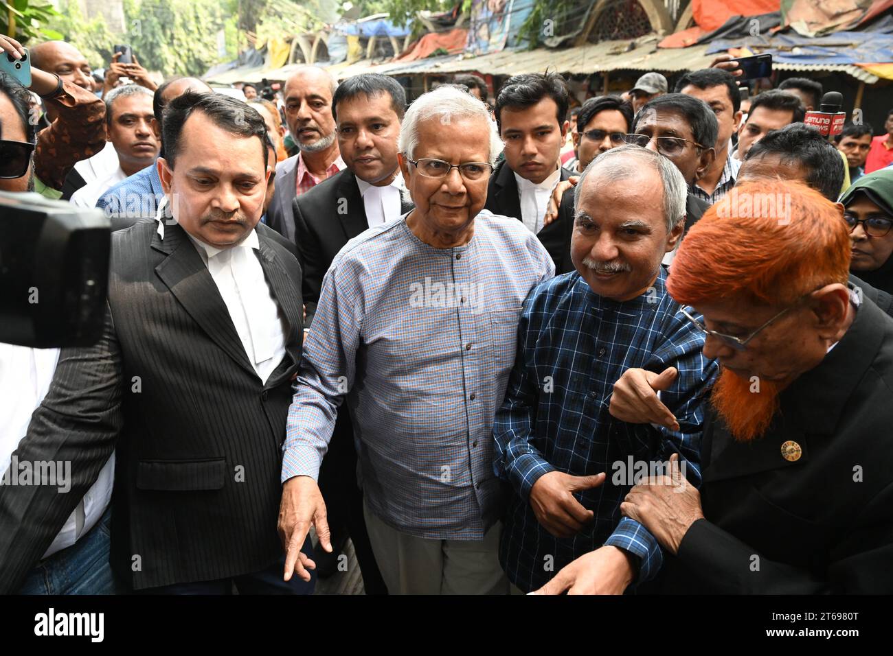 Nobel laureate Muhammad Yunus (C) arrives with his lawyers for a ...