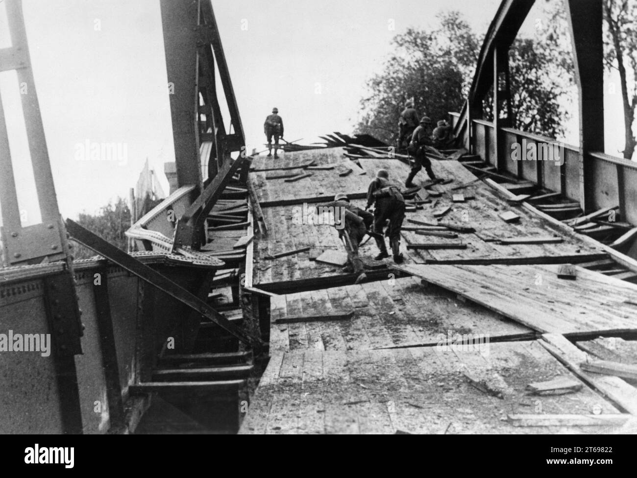 German soldiers cross the Jura River on the blown-up bridge and advance ...
