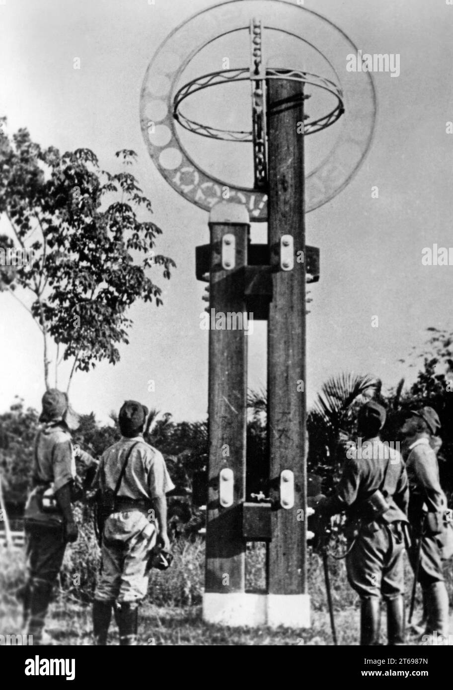 Japanese soldiers in front of a monument to the equator at Pontianak on ...