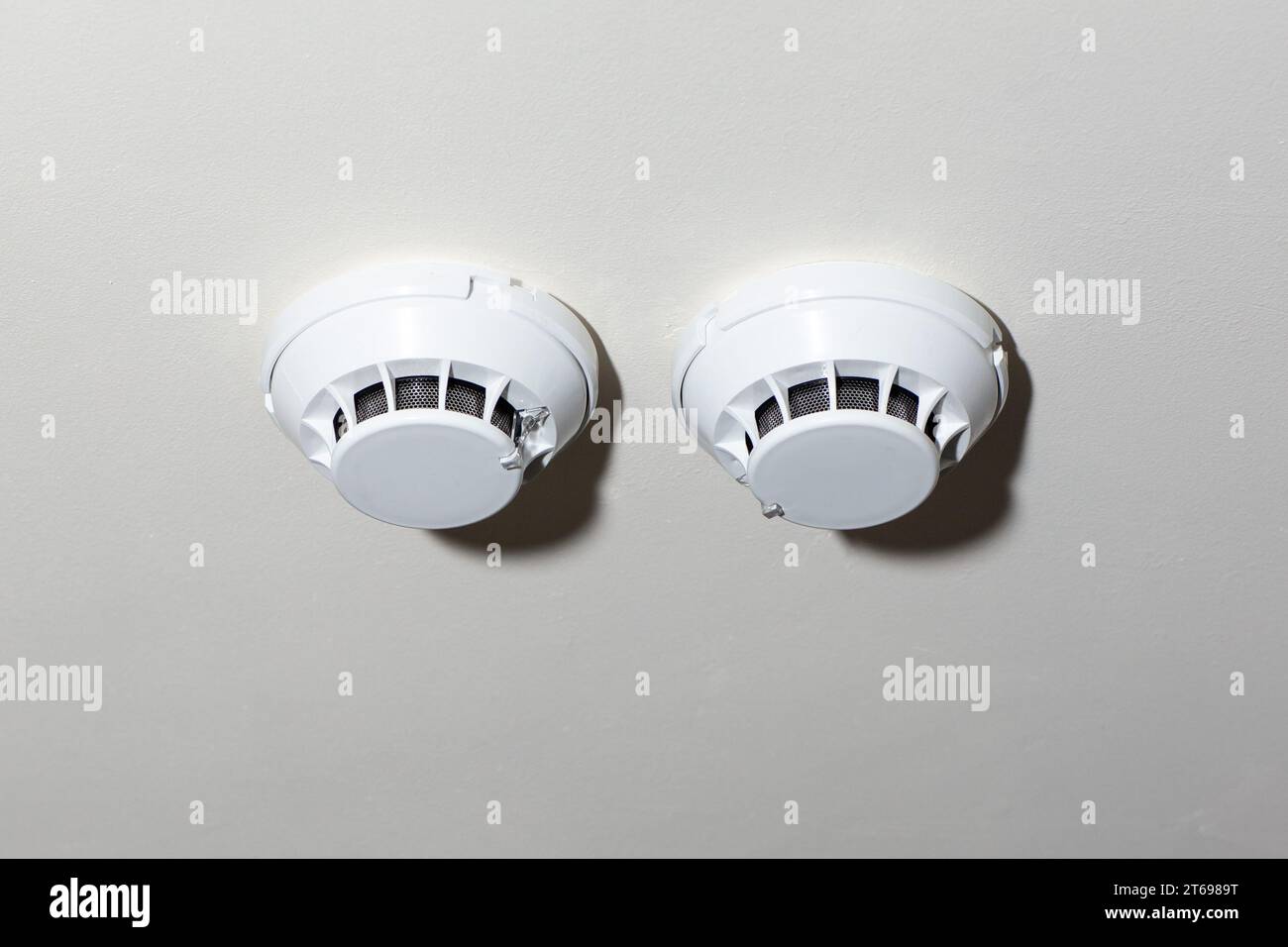 White ceiling-mounted smoke detectors for fire safety and protection ...