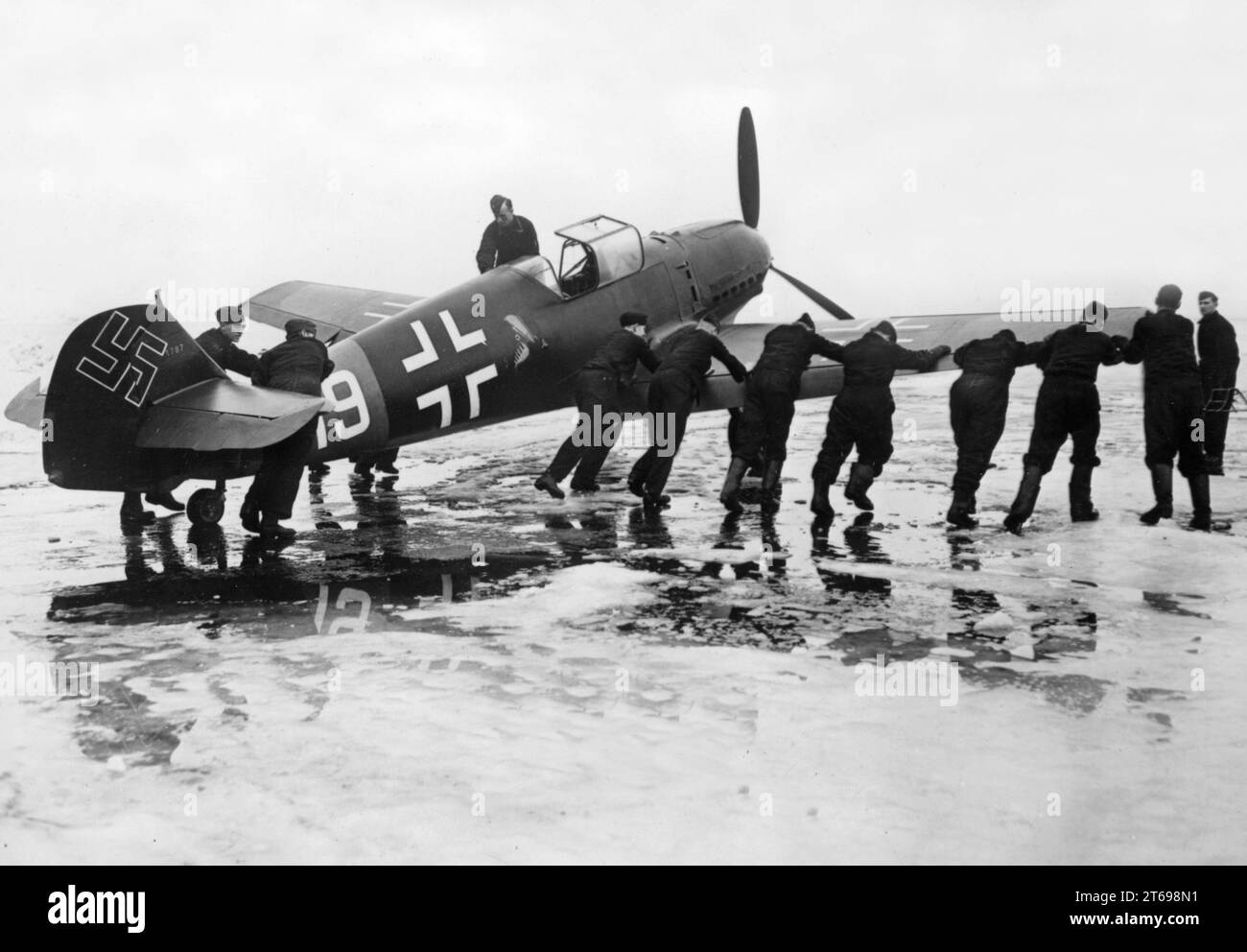 A Messerschmitt Me BF 109 fighter plane is pushed onto the runway of a German fled airfield by ...