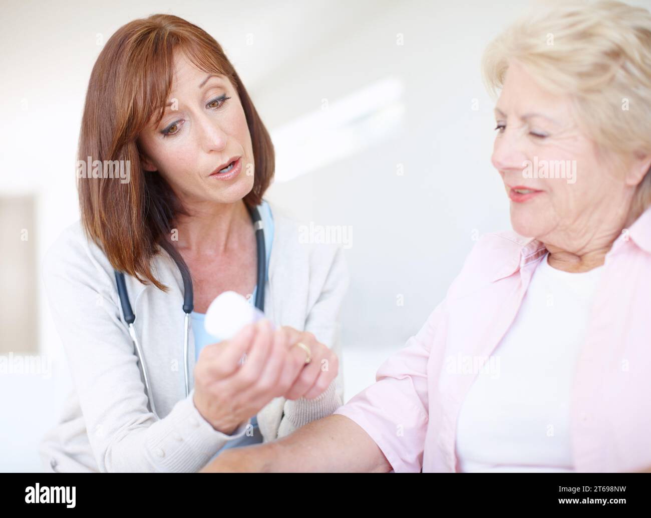 Prescription medication - Senior Care. Mature nurse explains the dosage ...
