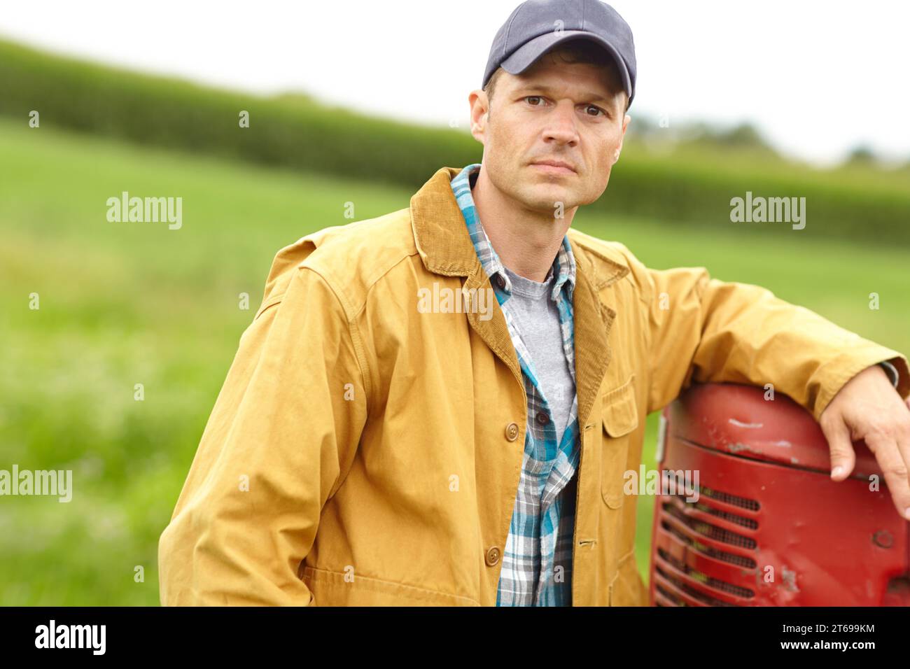 Serious about farming. Portrait of a serious farmer with his arm ...
