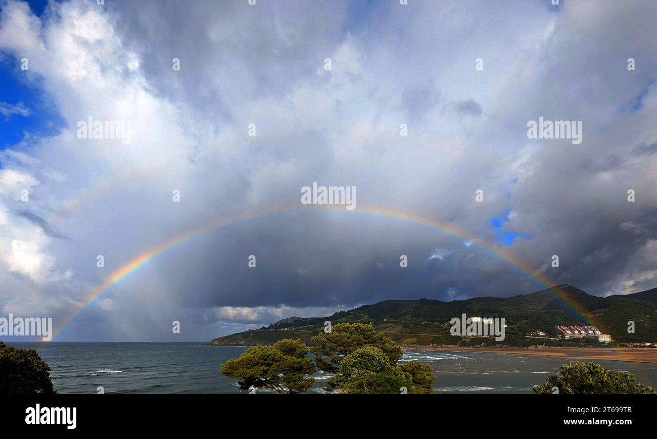 A beautiful full rainbow over the sea near Mundaka in the Basque region ...