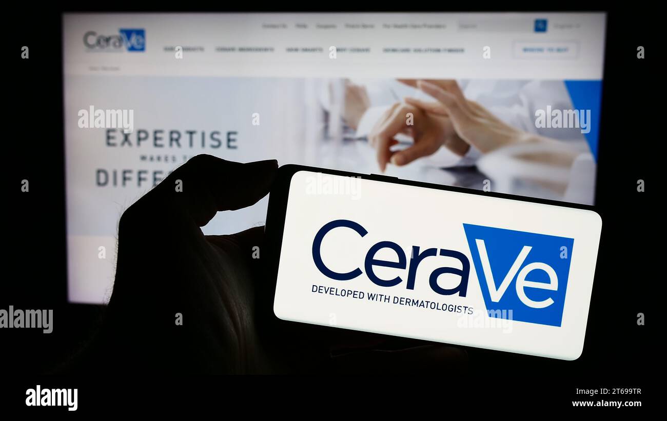 Person holding mobile phone with logo of personal care company CeraVe ...