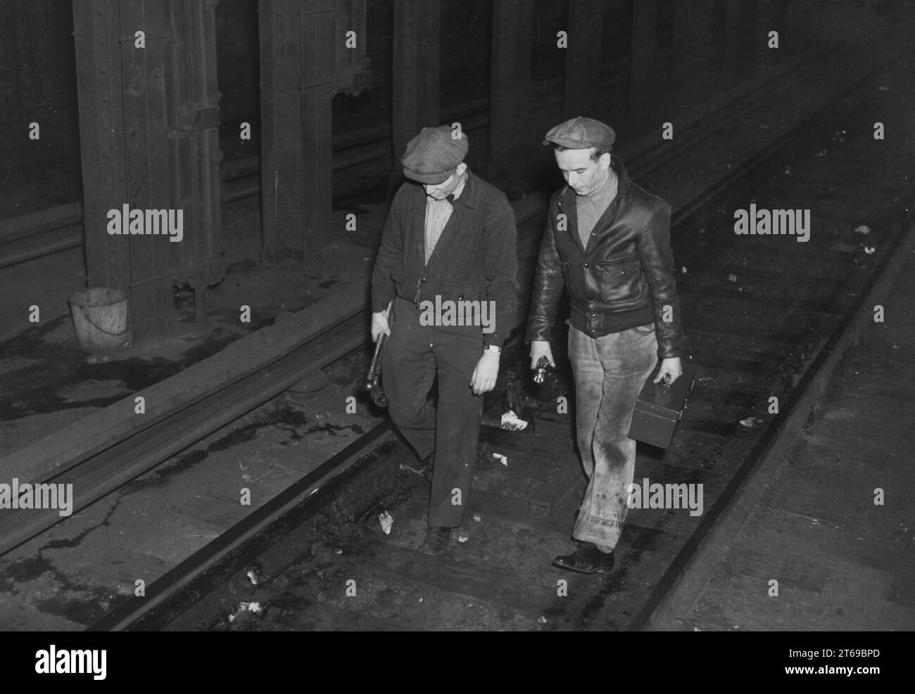 Men check rails and signals on the New York subway, here between 50th ...