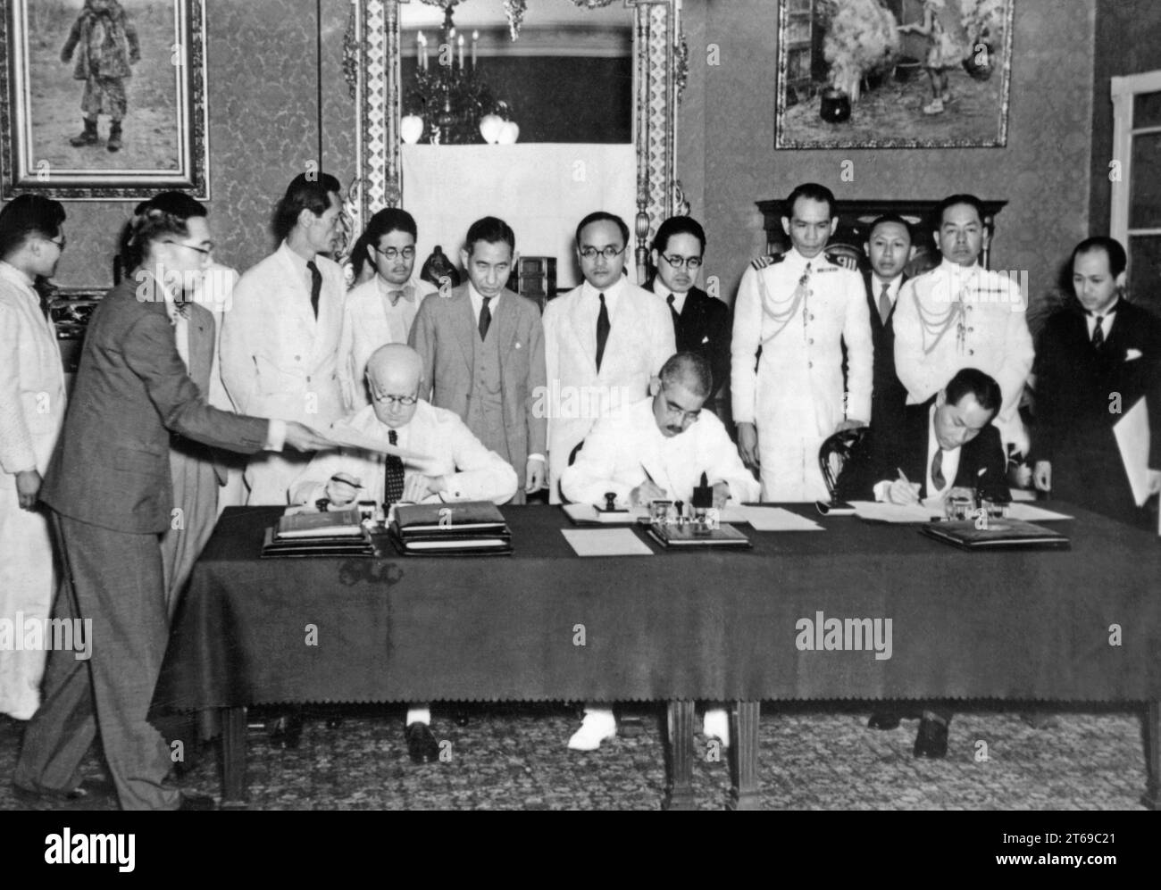 Japanese Foreign Minister Yosuku Atsuoka (center) signs an agreement to ...