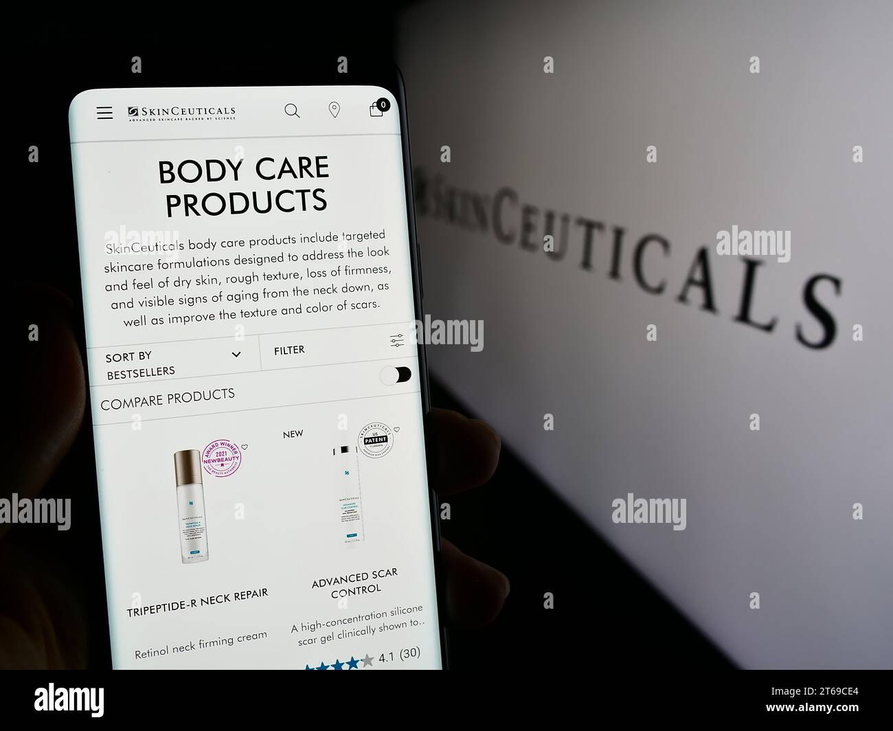 Person holding smartphone with web page of cosmetics company ...