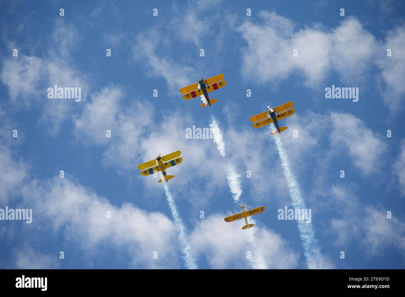 Four airplanes flying in formation, leaving trails of smoke behind them ...