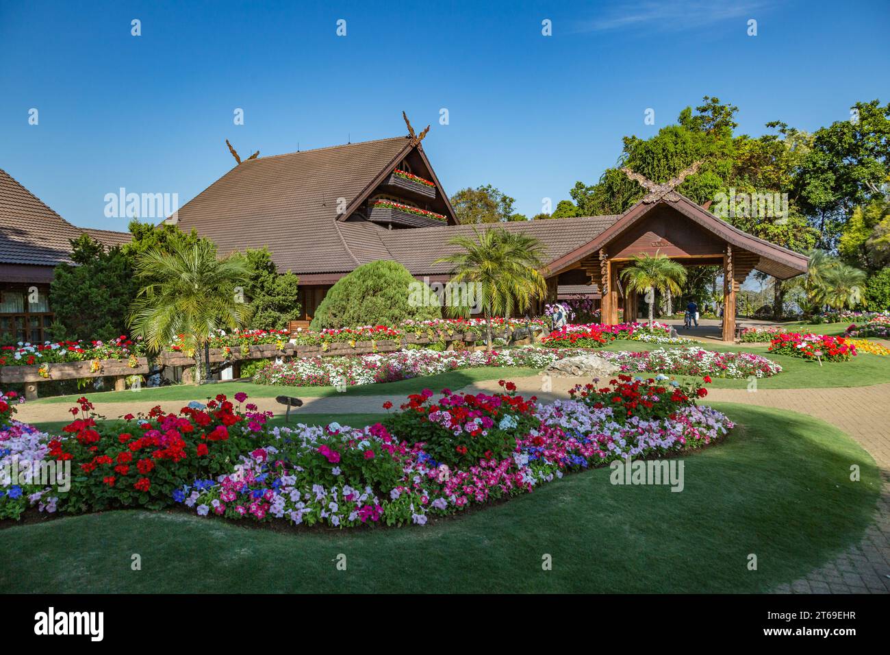 Palm trees and flower gardens enhance the Lanna and Swiss architecture ...