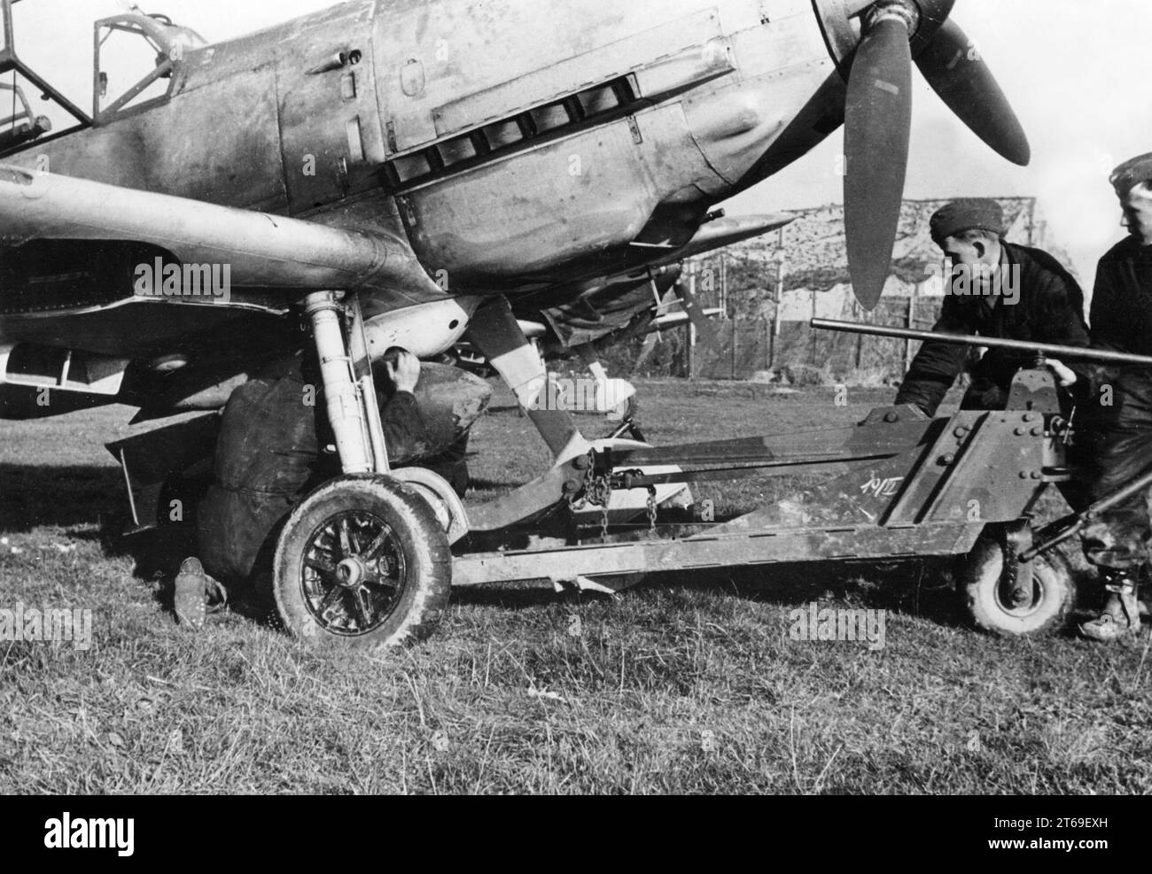 Wait attach an aerial bomb under the fuselage of a Messerschmitt Me BF 109 during the Battle of ...