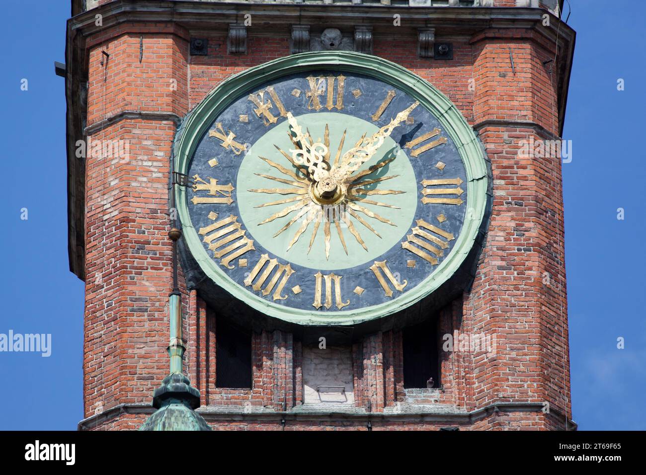 The close view of a giant clock on a top of medieval tower in Gdansk ...