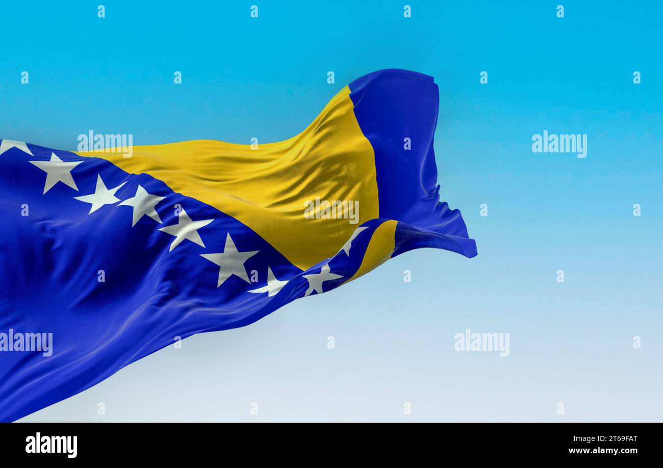Flag of Bosnia and Herzegovina waving in the wind. Blue field with ...