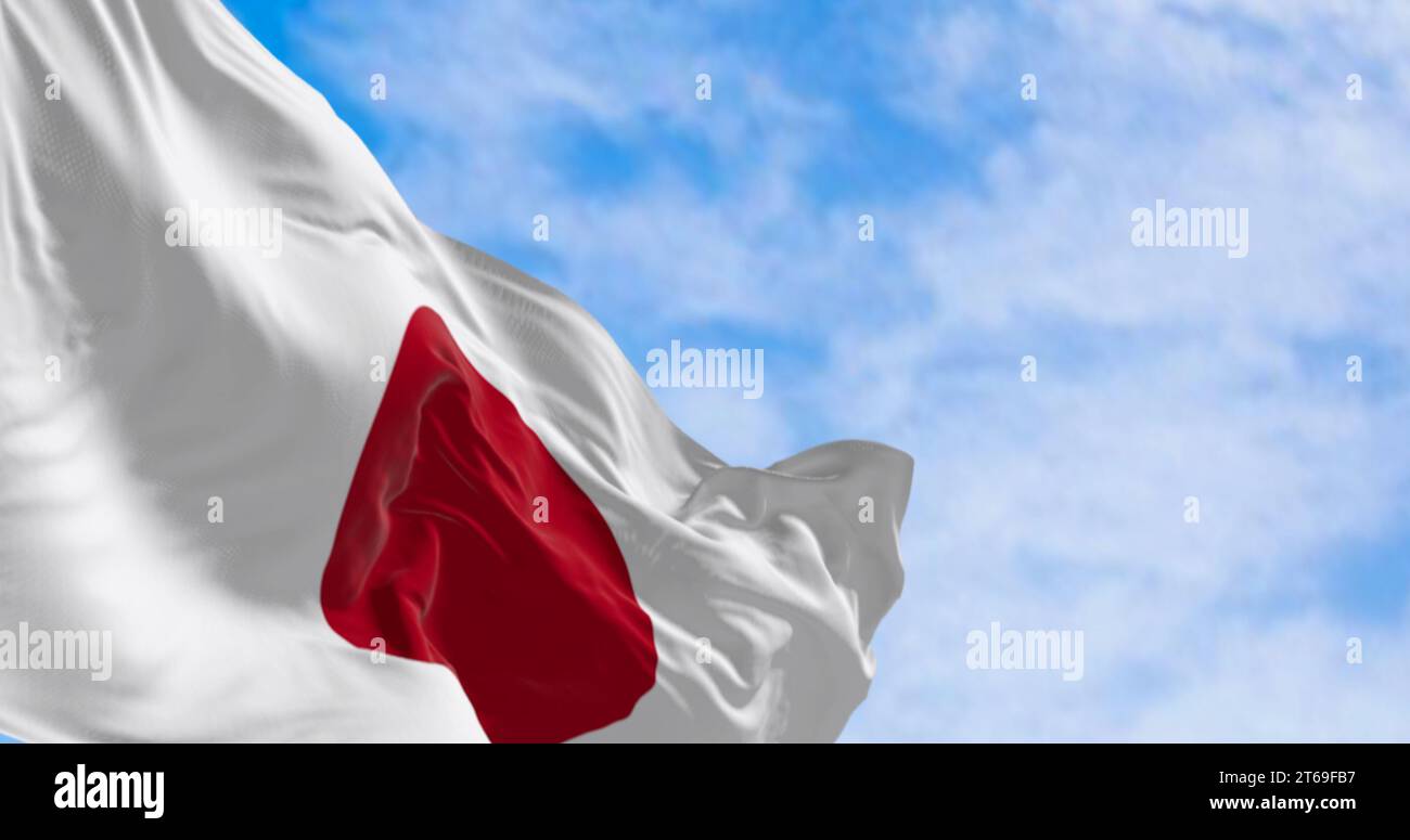Japan national flag waving in the wind on a clear day. Red disc on a ...