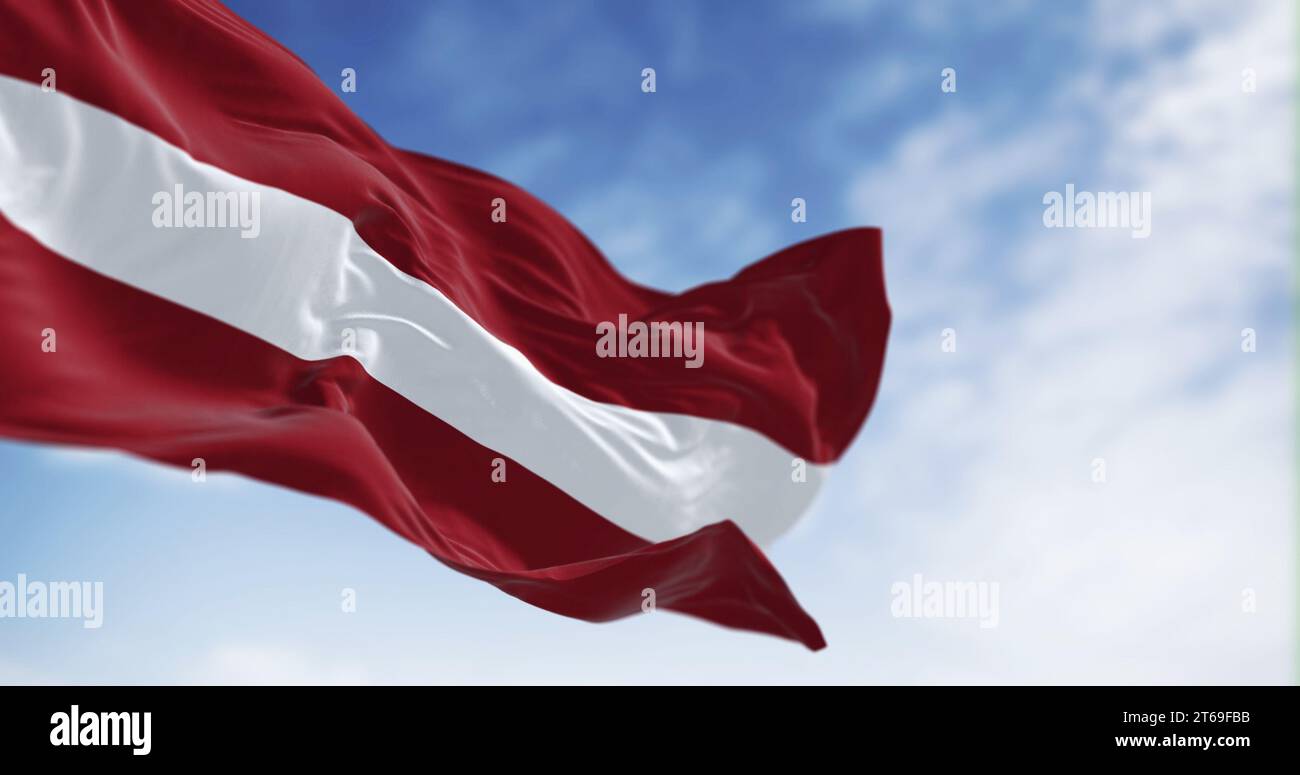 Republic of Latvia national flag waving in the wind on a clear day. Red ...