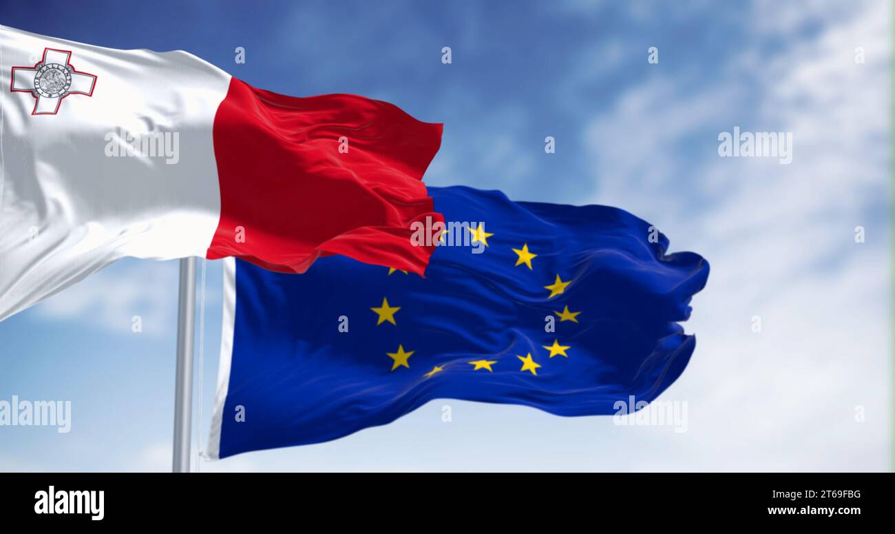 Flags of Malta and the European Union waving in the wind on a clear day ...