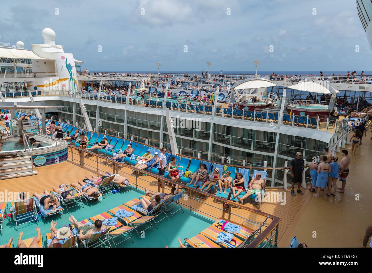 Cruise passengers enjoying the pool deck on the Royal Caribbean Allure ...
