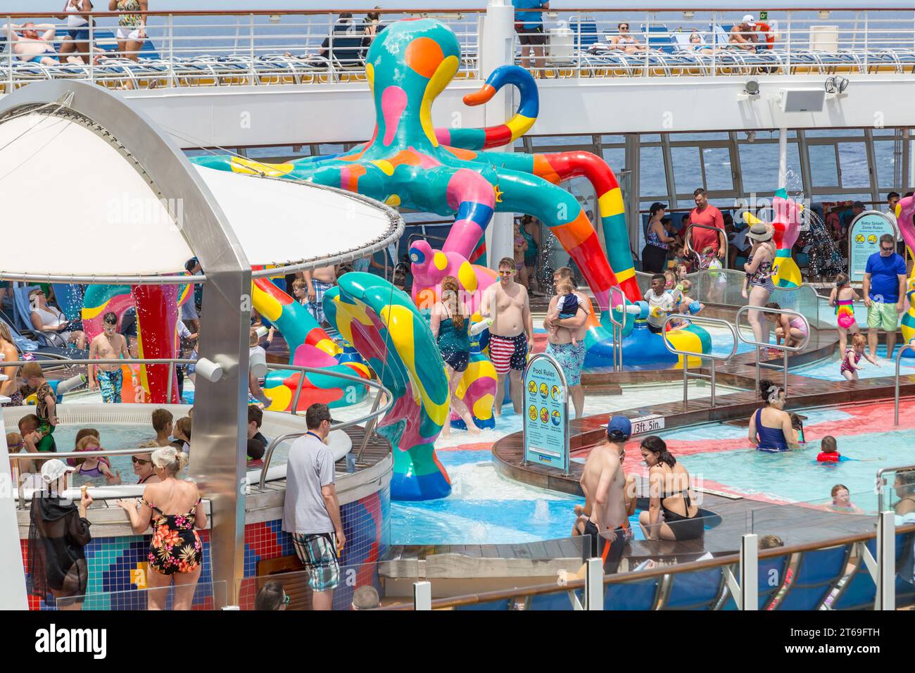 Cruise passengers enjoying the pool deck on the Royal Caribbean Allure ...