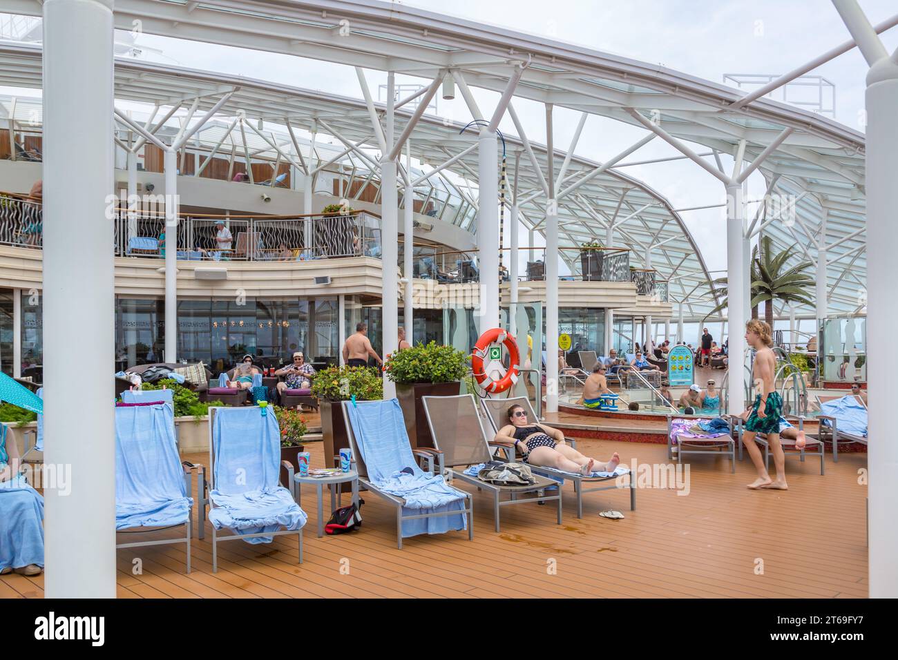 Adult cruise passengers enjoying the pool at the Solarium on the Royal ...