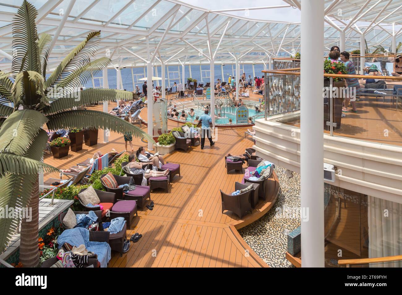 Adult cruise passengers enjoying the pool at the Solarium on the Royal ...