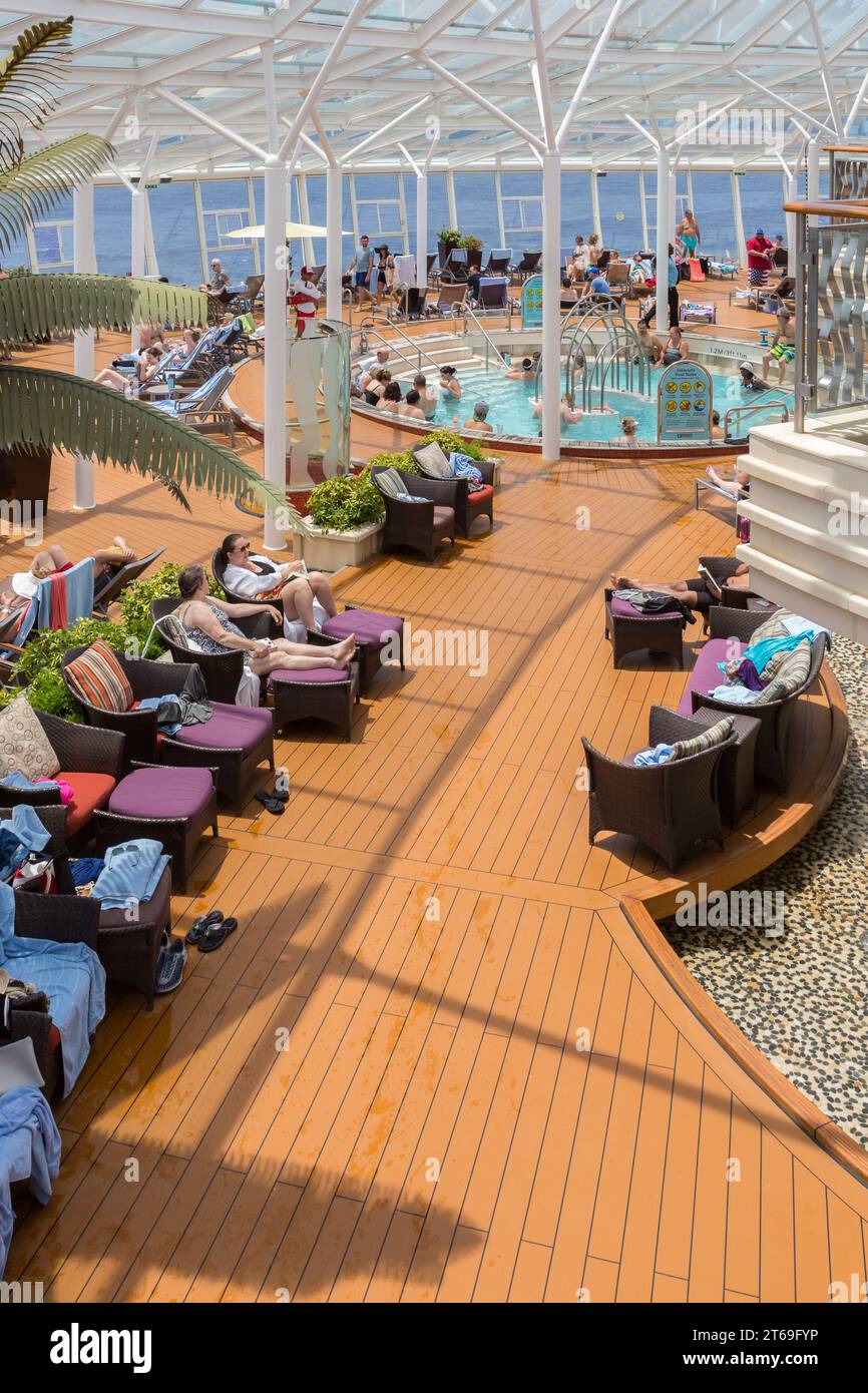 Adult cruise passengers enjoying the pool at the Solarium on the Royal ...