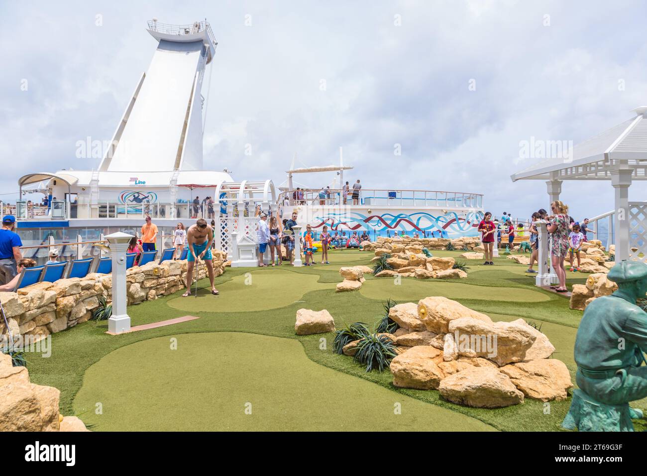 Cruise passengers playing miniature golf on the Royal Caribbean Allure ...