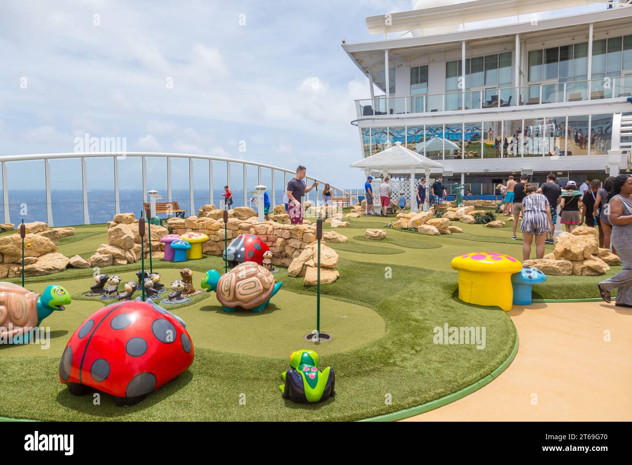 Cruise passengers playing miniature golf on the Royal Caribbean Allure ...