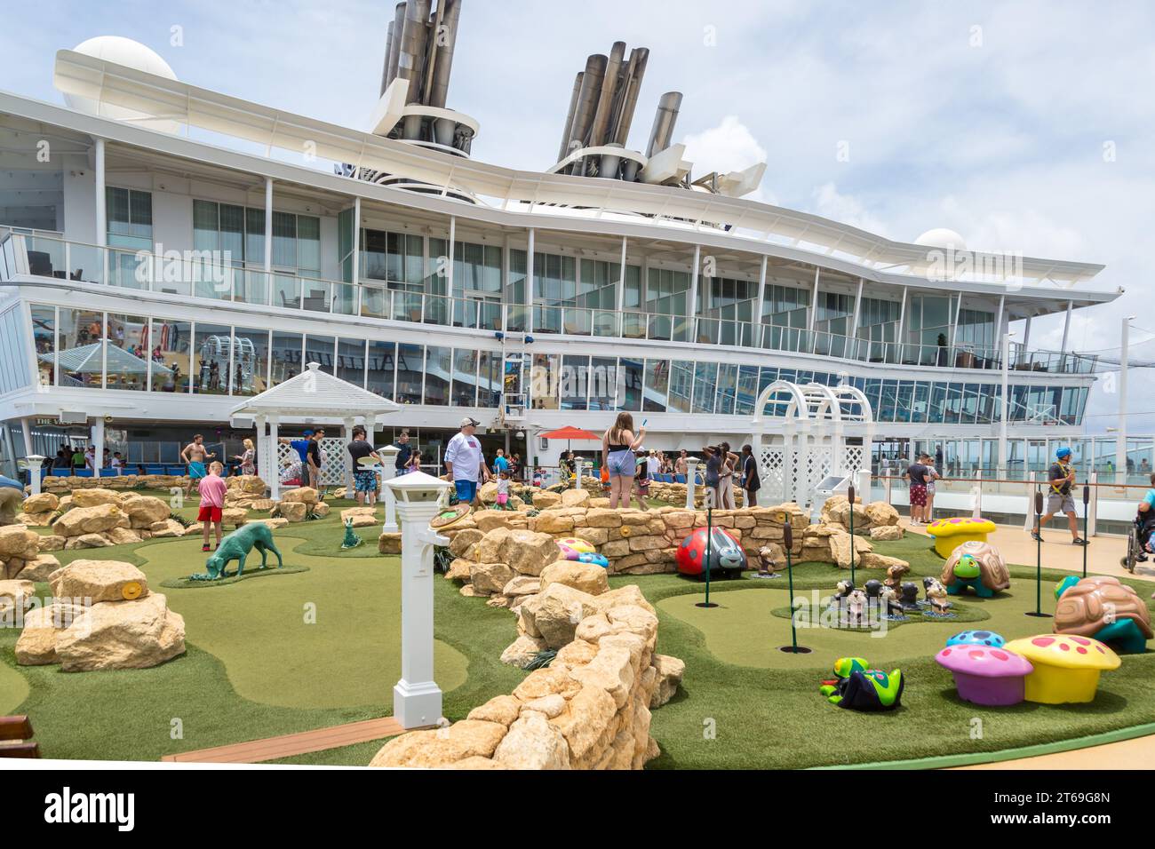 Cruise passengers playing miniature golf on the Royal Caribbean Allure ...