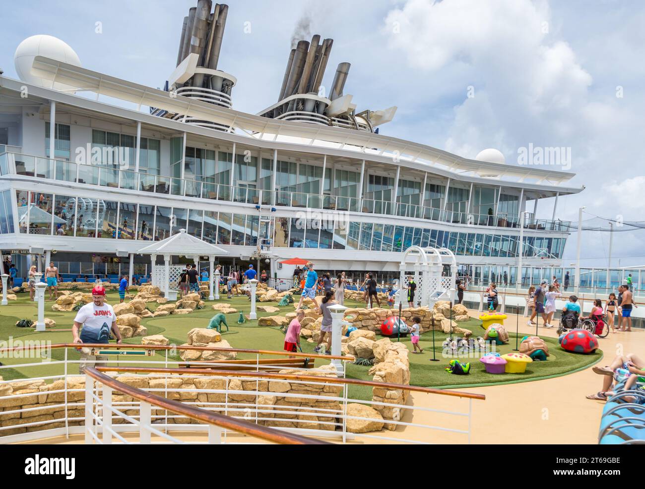Cruise passengers playing miniature golf on the Royal Caribbean Allure ...
