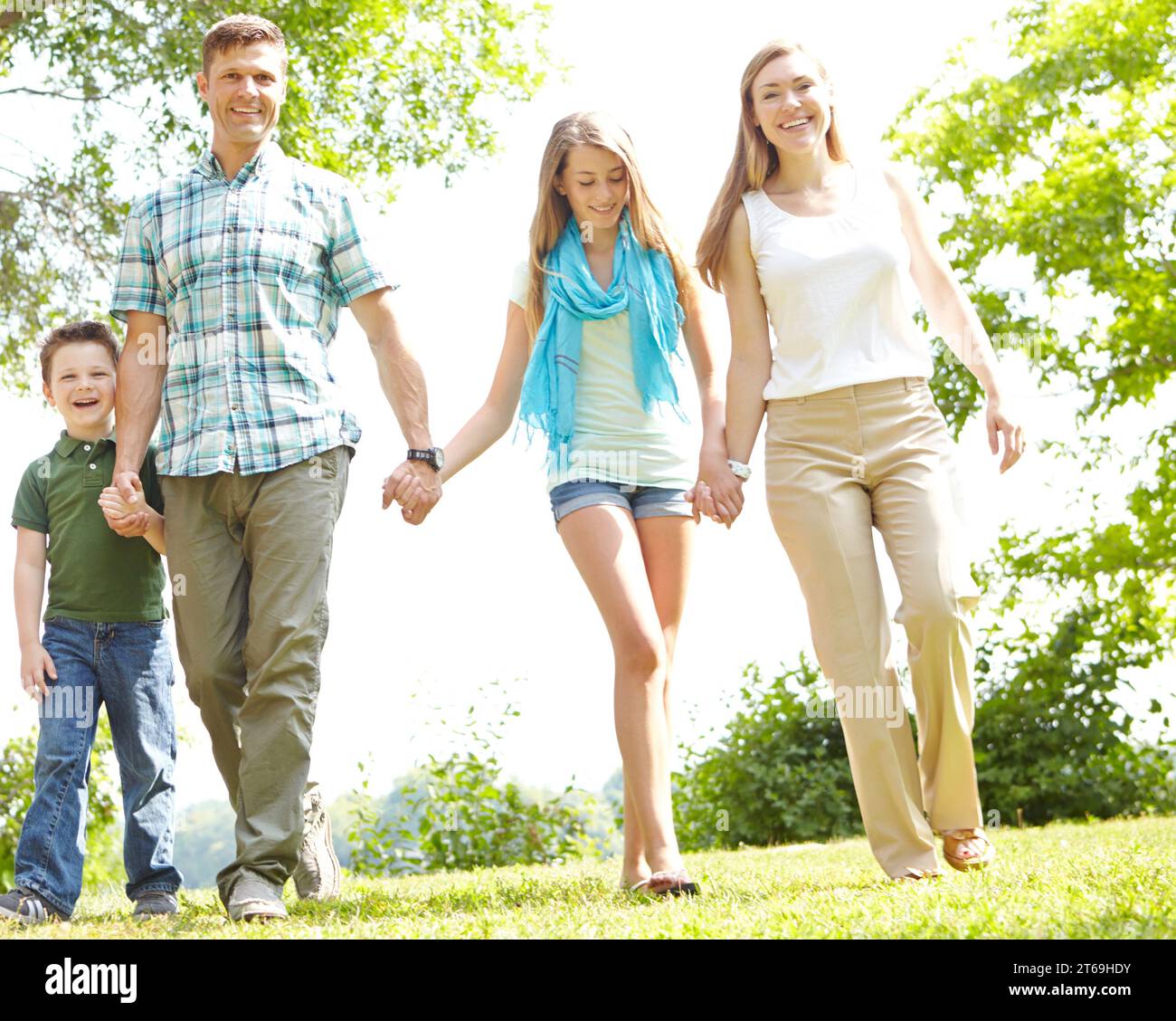 Summer strolls as a family. A happy young family walking through the ...