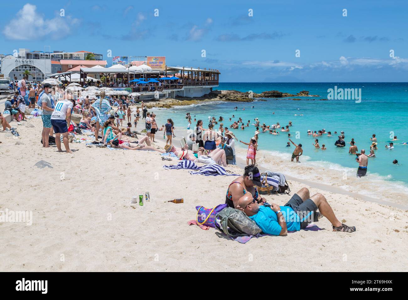 Tourists at Maho beach on the island of St. Maarten in the Caribbean ...