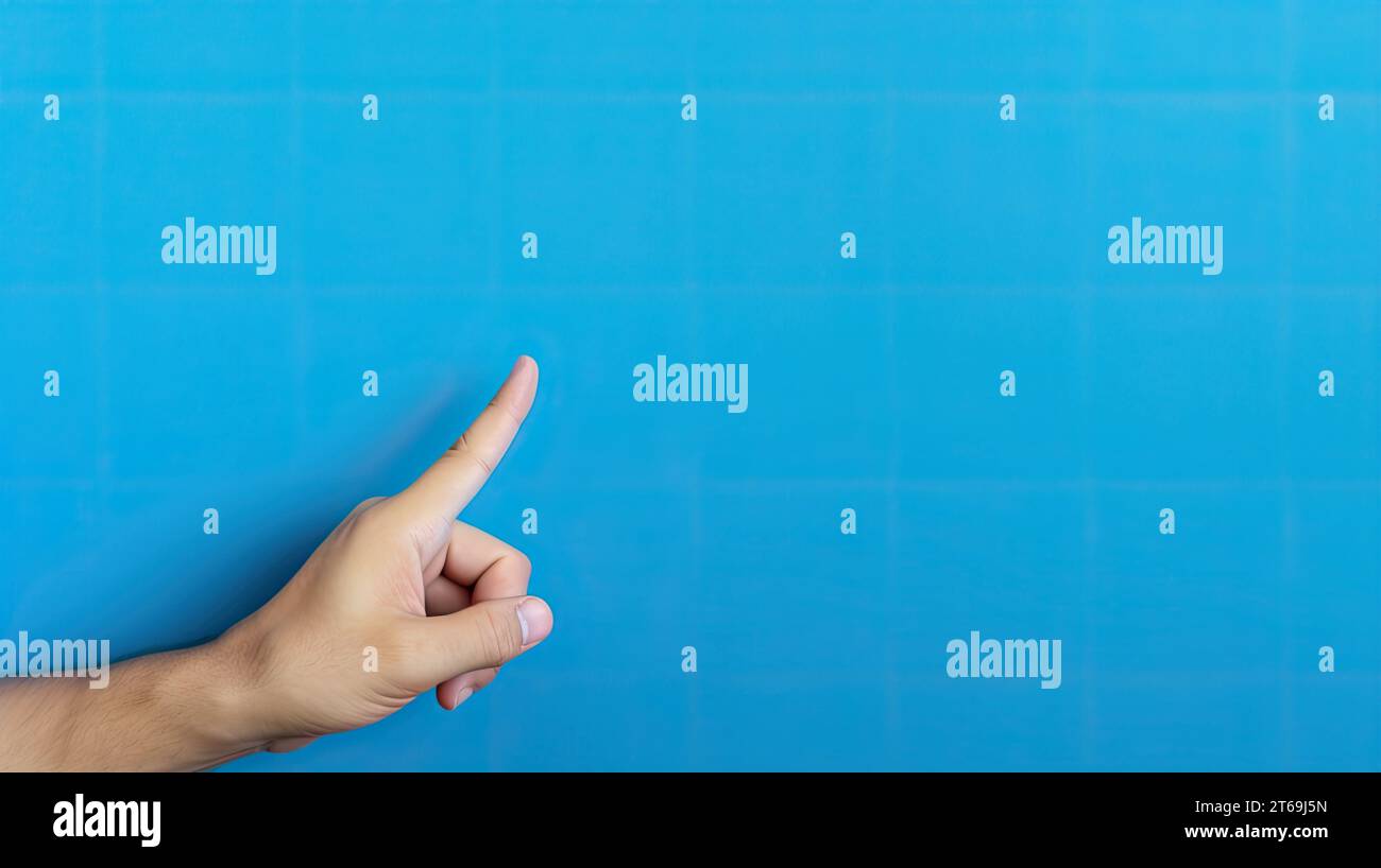A male finger in a pointing gesture towards a blue background Stock ...