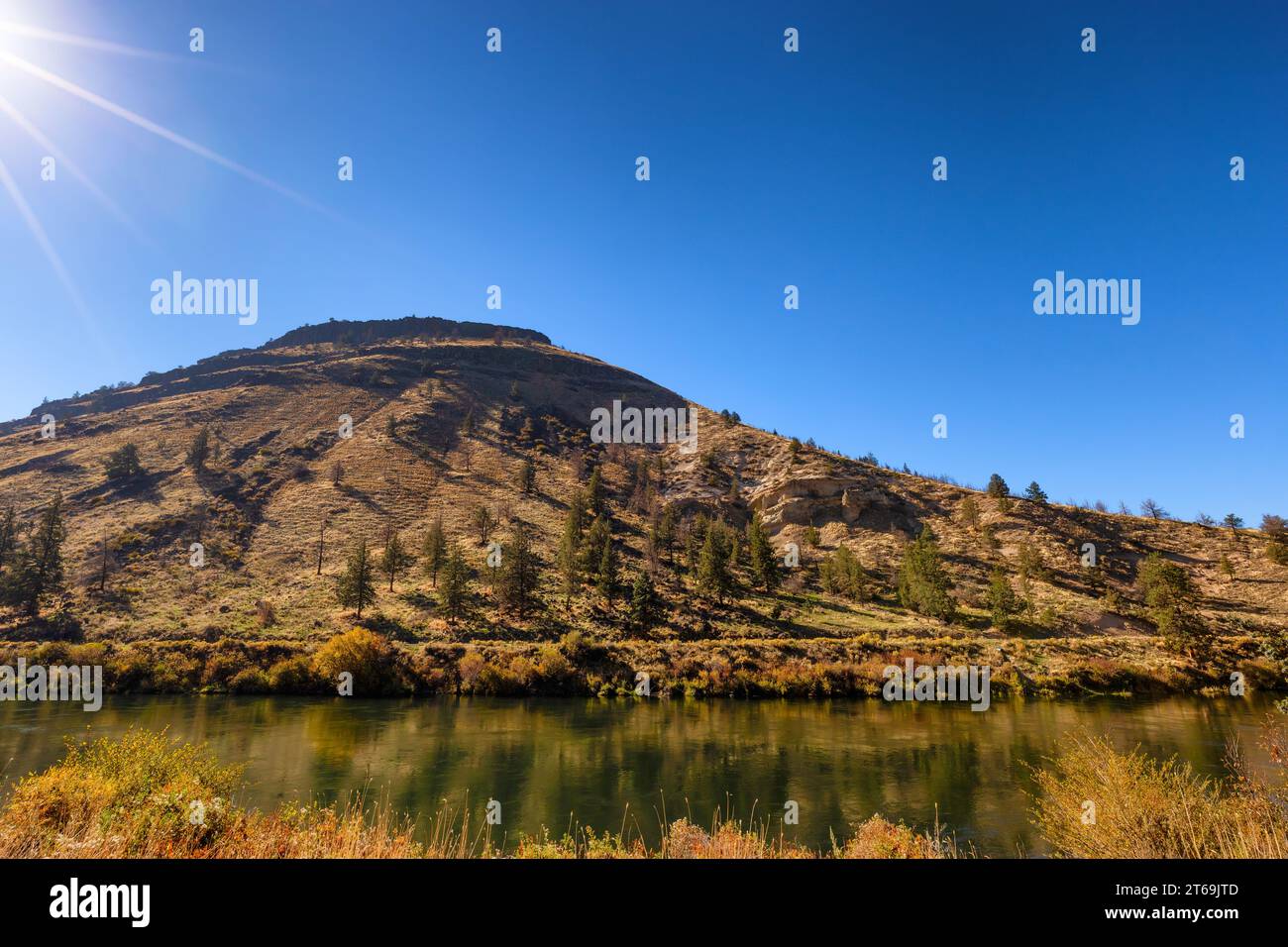 Rimrock cliffs made of Basalt rock stands above the Deshutes River ...