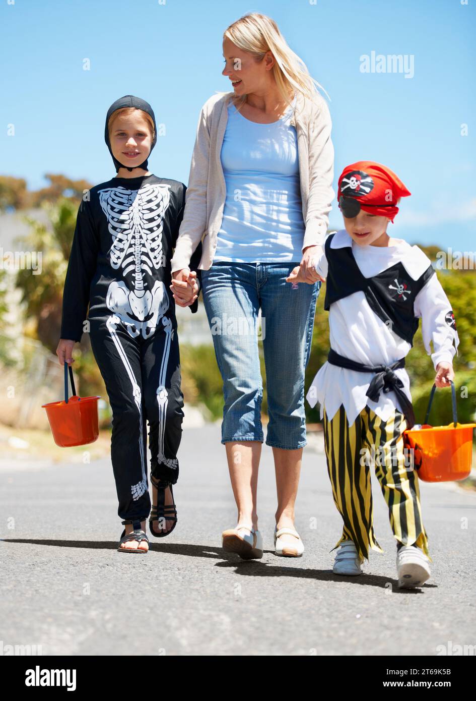 Going trick or treating. Children in costume going treat or treating ...