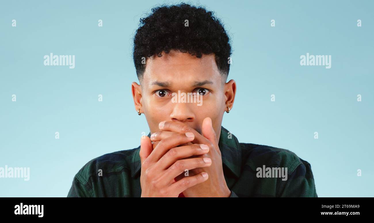 Anxiety, fear and hands on face of man in studio with emoji surprise ...