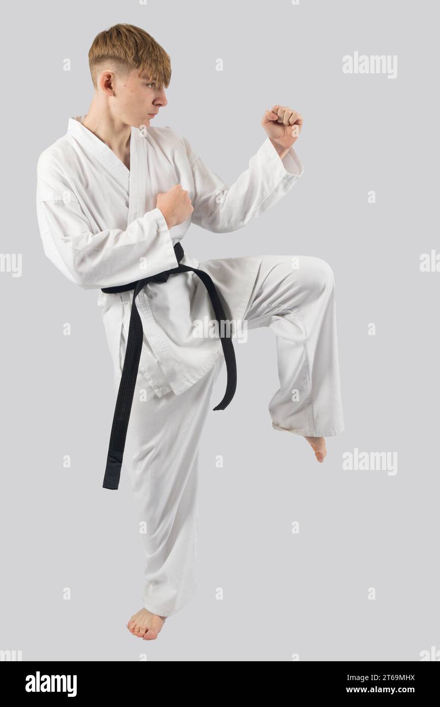 Black belt teenage boy abput to kick Stock Photo - Alamy