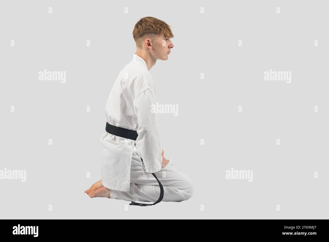 Black belt teenage boy in Seiza, kneeling down Stock Photo - Alamy