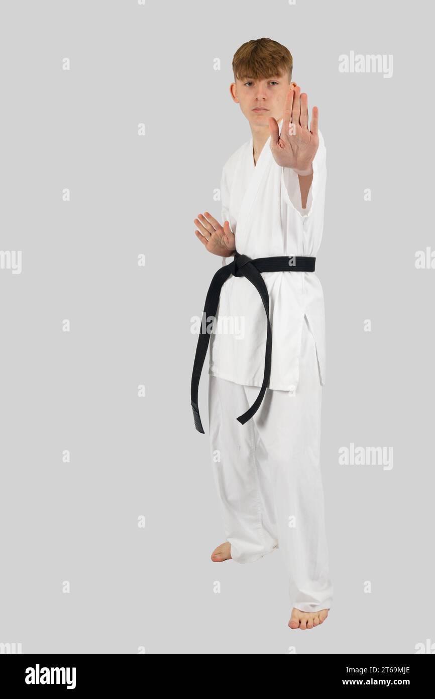 Black belt teenage boy performing a palm heel strike Stock Photo - Alamy