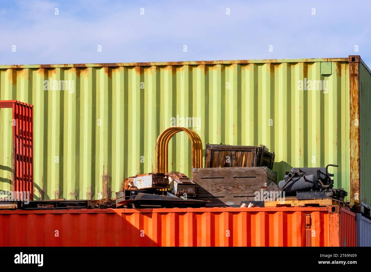 Bright and colorful shipping containers with junk piled on them Stock ...