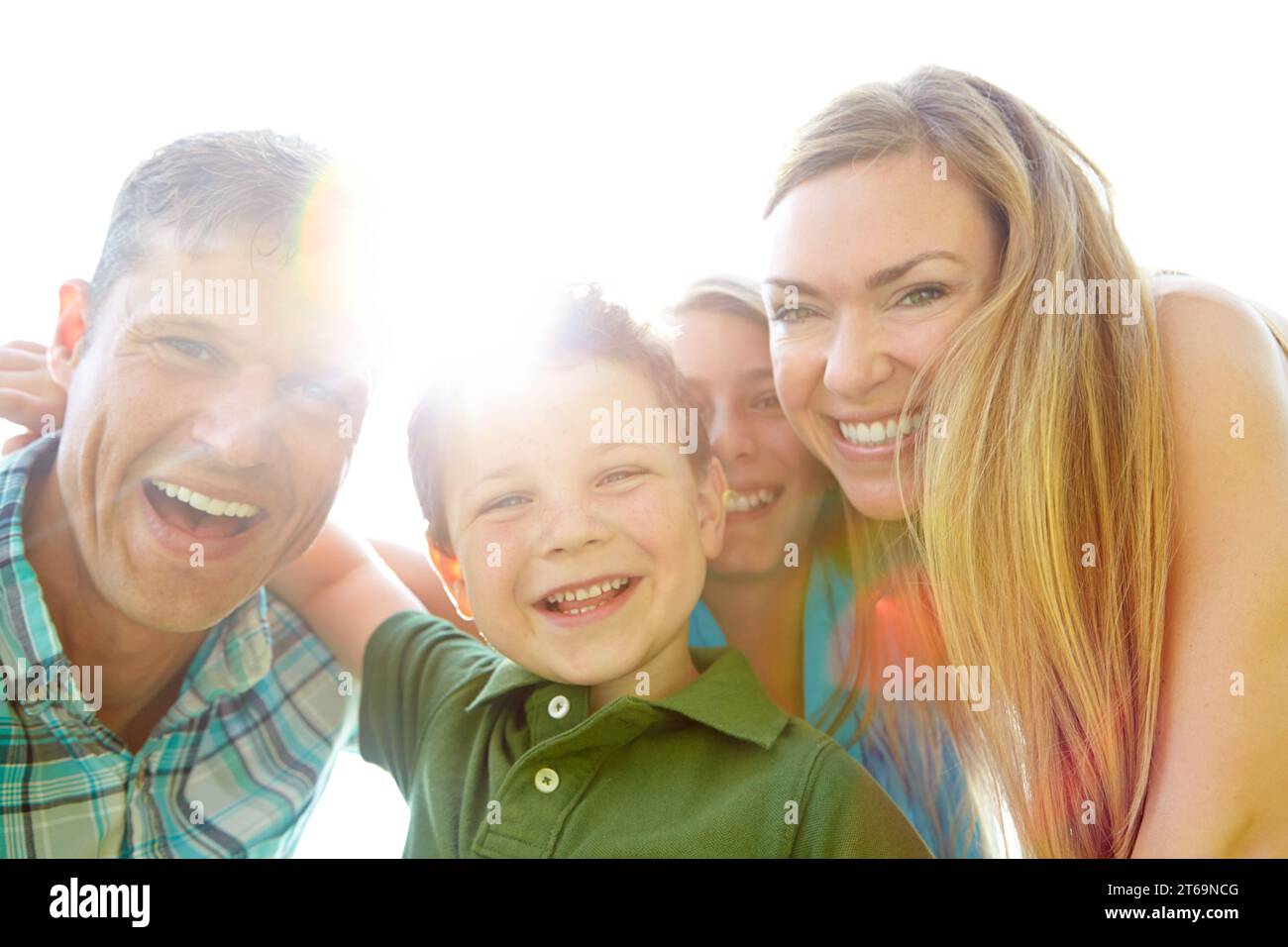Summer family fun. A cute young family spending time together outdoors ...